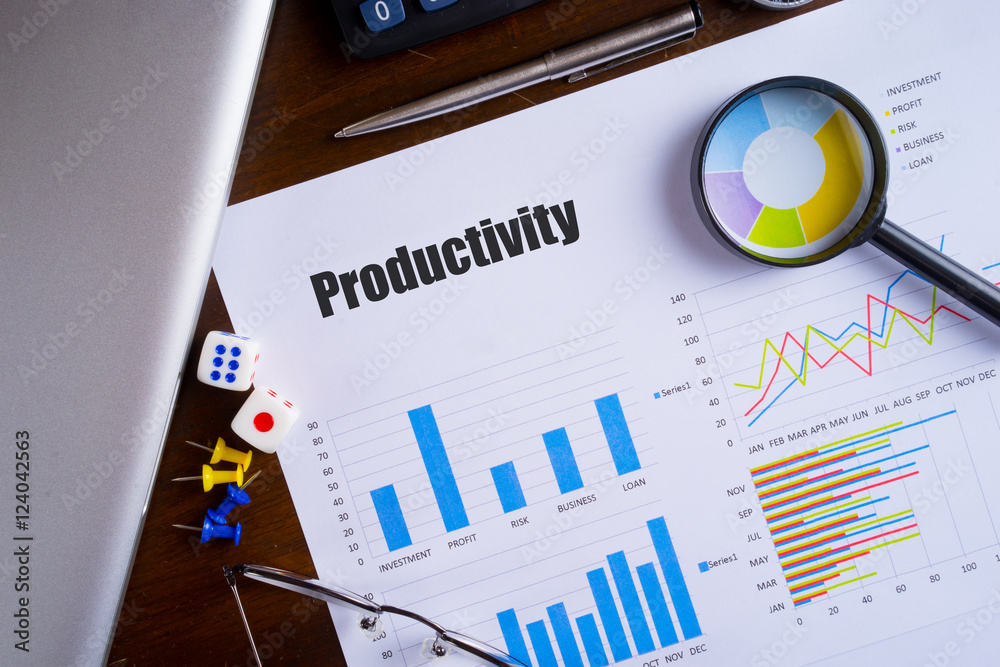 "Productivity" text on paper sheet with magnifying glass on chart, dice ...