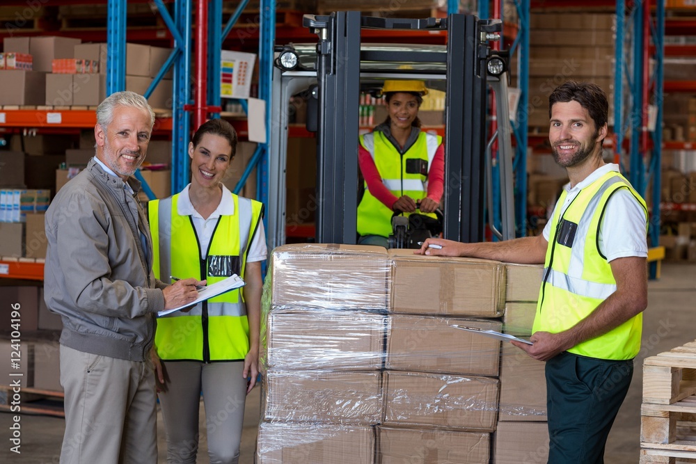 Warehouse manager and workers preparing a shipment Stock Photo | Adobe ...