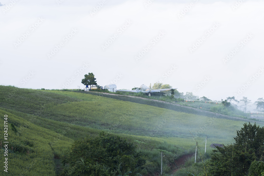 Old airplanes parked in a spot surrounded by mist. A tourist attraction ...