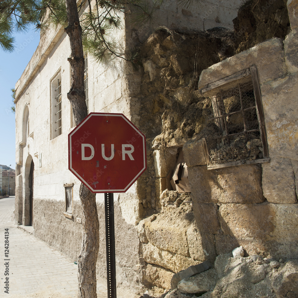 Stop sign in turkish language beside a building;Mustafapasa nevsehir ...