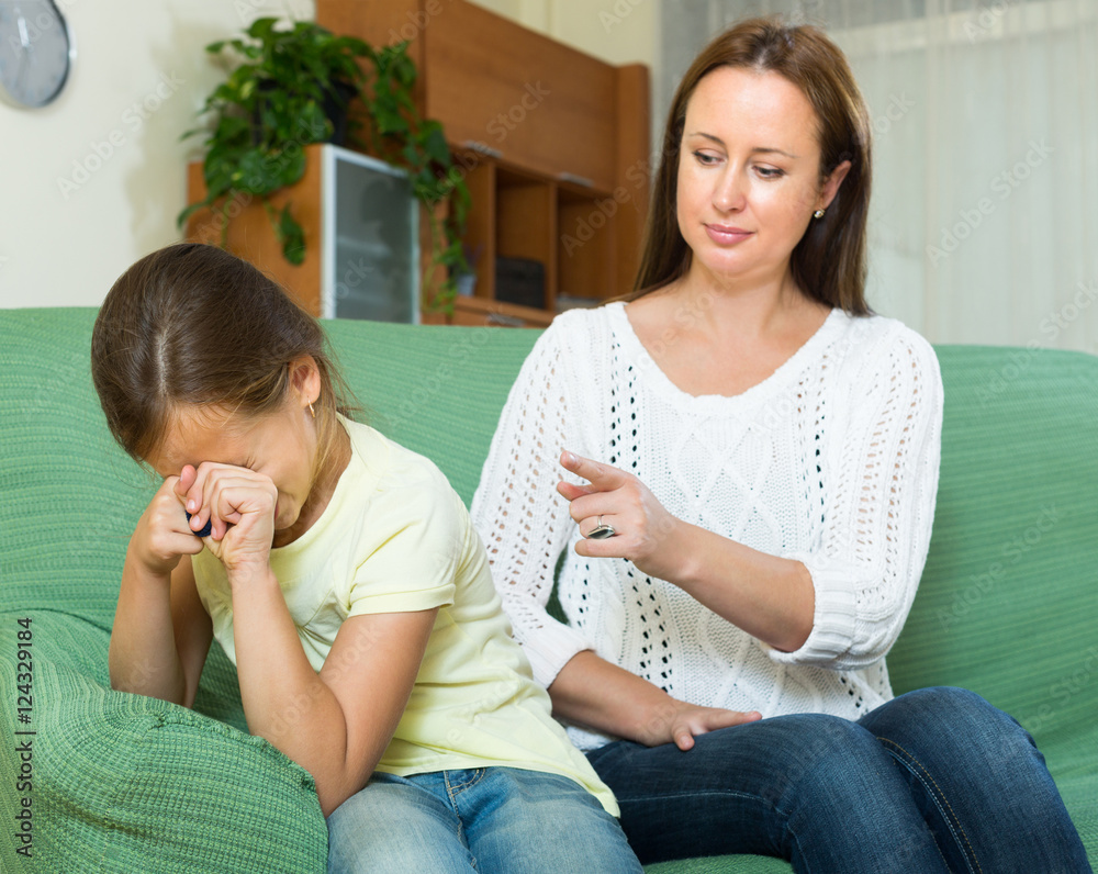 Woman berating crying daughter Stock Photo | Adobe Stock