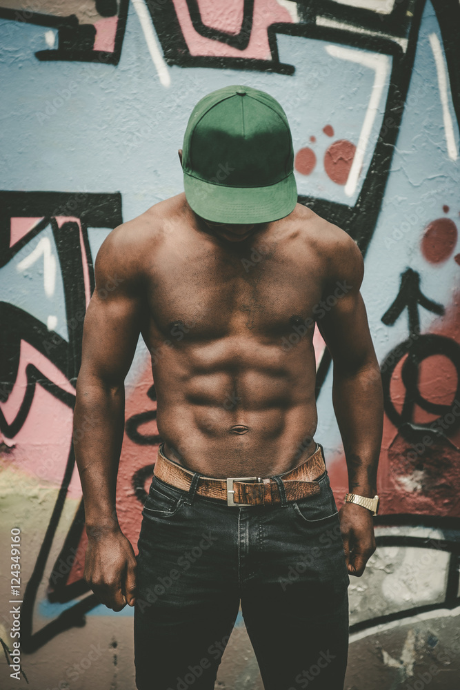 Faceless african man posing on graffiti background Stock Photo | Adobe ...