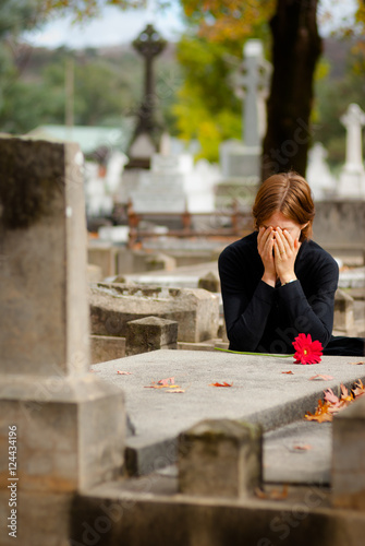 People Crying At A Grave