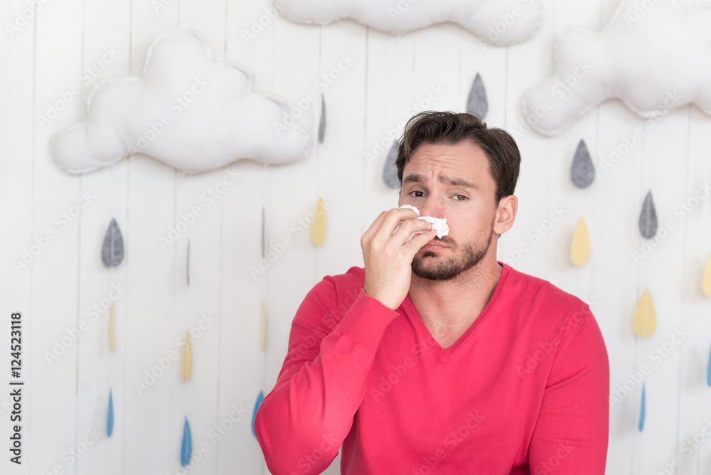 Sad miserable man wiping the nose with a paper tissue Stock Photo ...