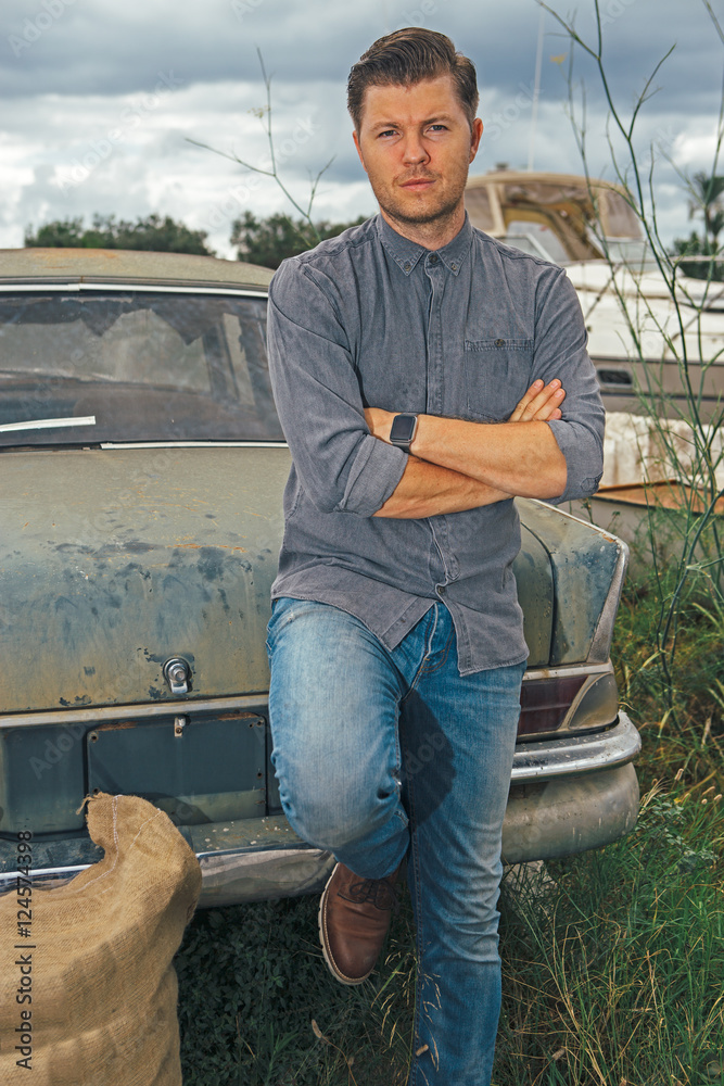 Serious handsome man at rusty retro car Stock Photo | Adobe Stock