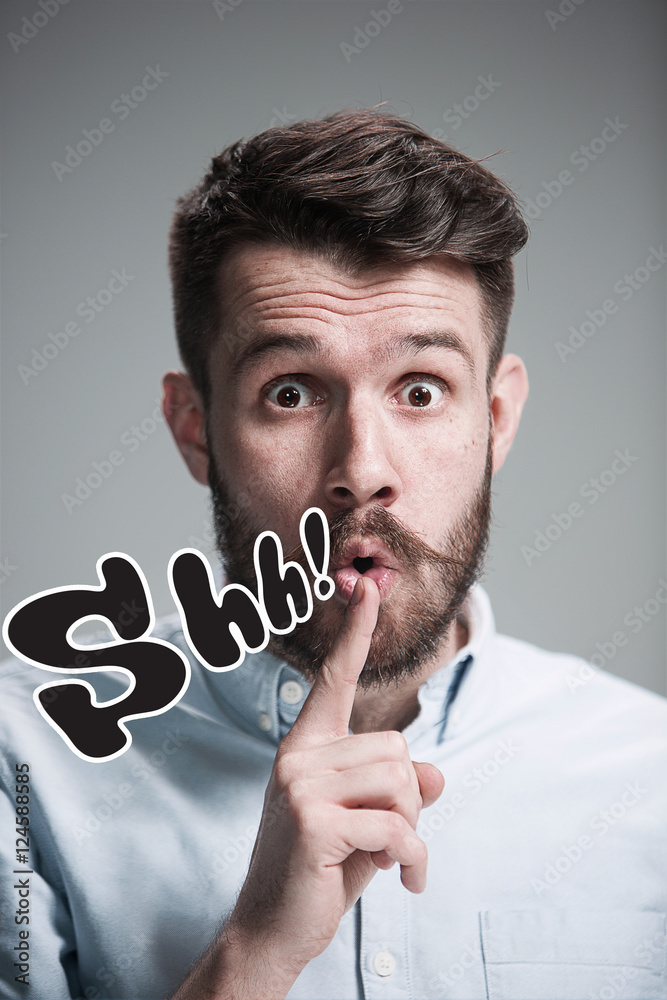 Man is looking wary. Over gray background Stock-Foto | Adobe Stock