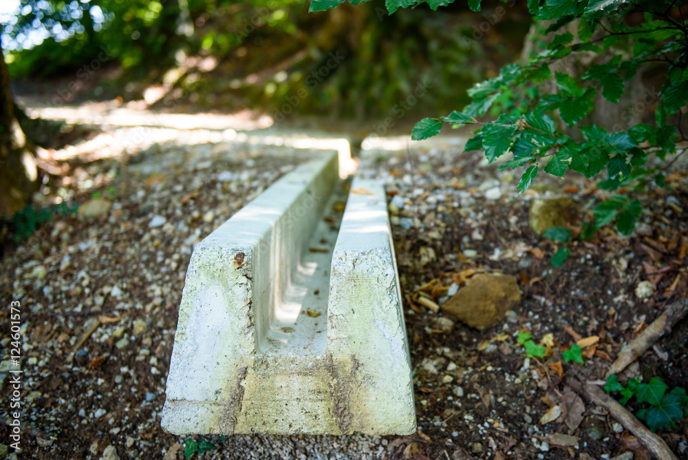 Concrete storm rain drainage on a footpath in the forest. Stock Photo ...