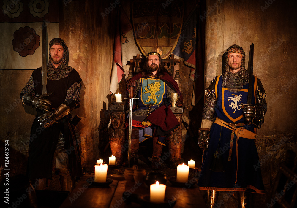 Medieval king with his knights in ancient castle interior Stock Photo ...