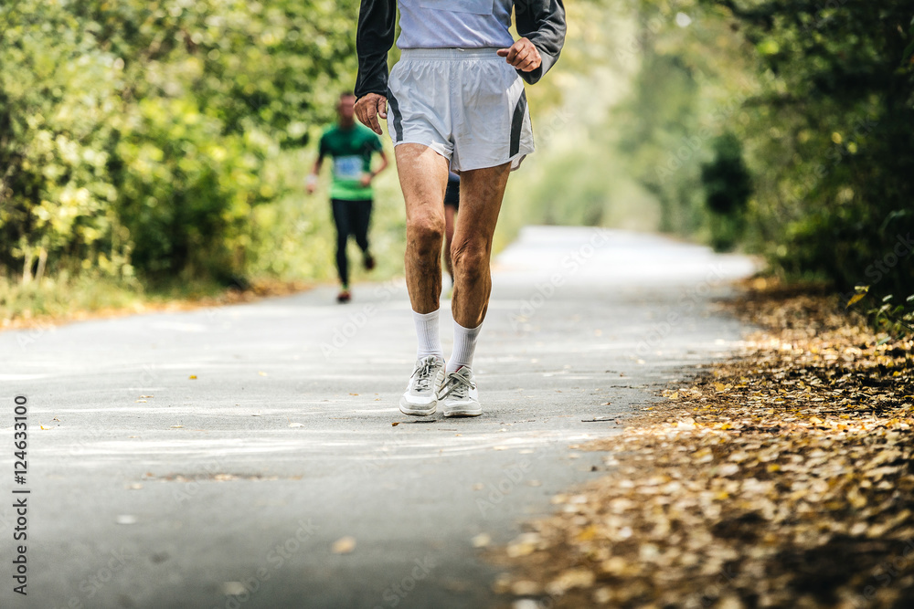 old man running in autumn Park. physical activity and a healthy ...