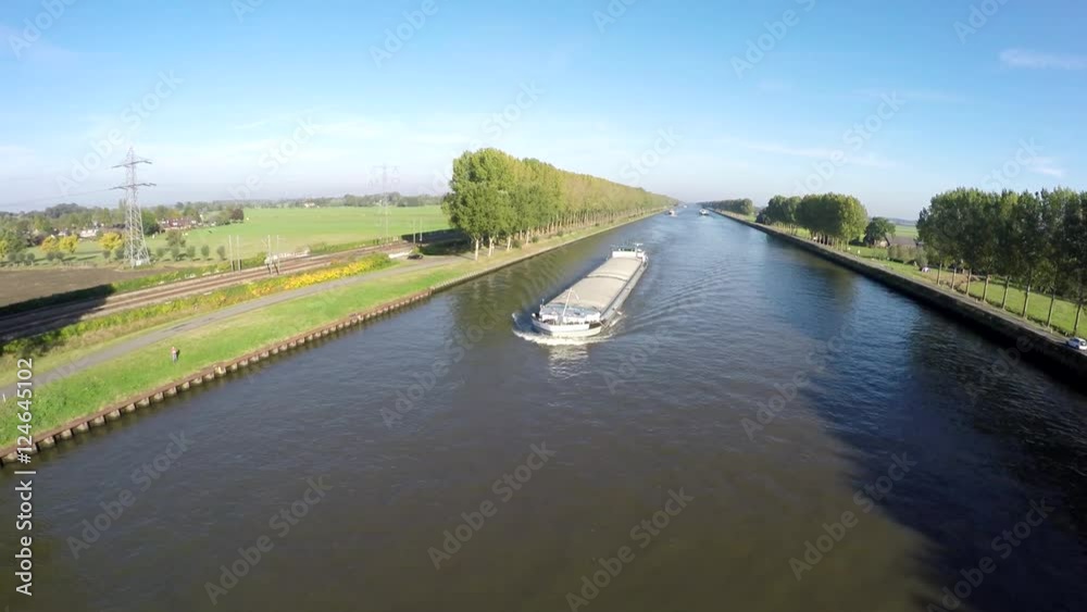 Aerial birds-eye view of barge drone flying backwards and up further ...