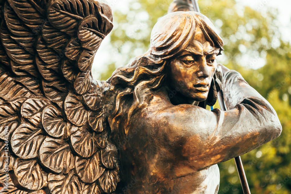 Statue Of Archangel Michael With Outstretched Wings Before Red Catholic ...