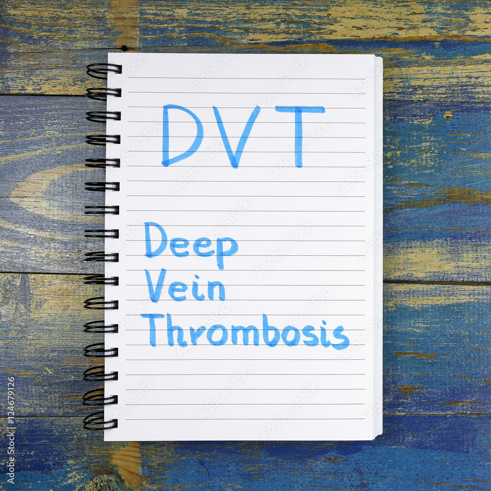 DVT- Deep Vein Thrombosis acronym written in notebook on wooden Stock ...