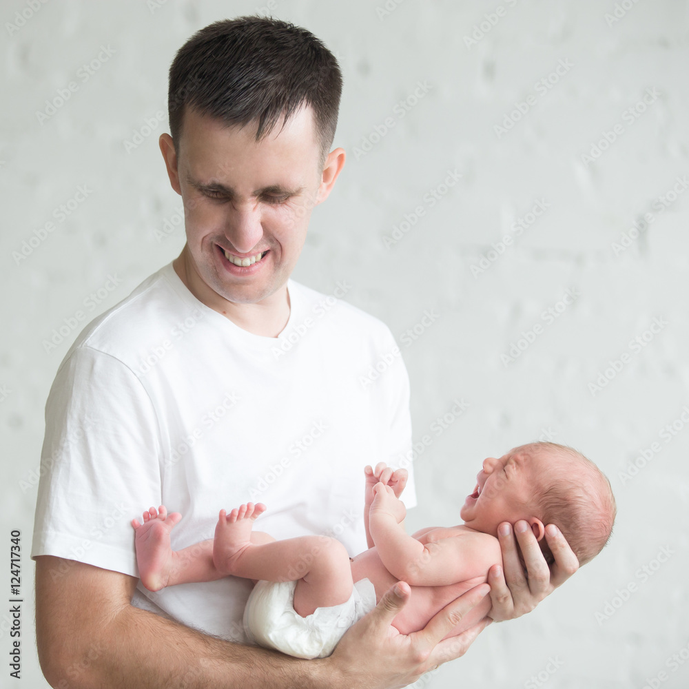 Man holding a screaming newborn in a diaper. Family, healthy birth ...