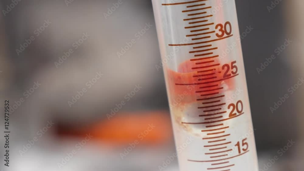 Hard Serbian rakija liquor beverage spirits measure in glass cylinder ...