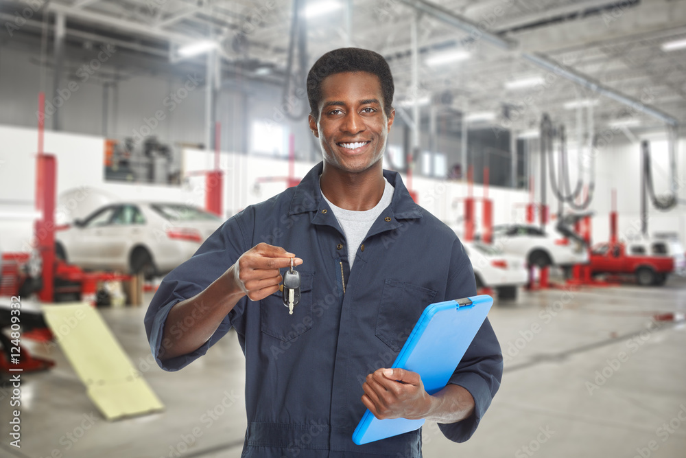 Car mechanic with key. Stock Photo | Adobe Stock