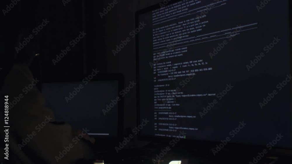 Hacker in hood cracking code using computers in dark room Stock ビデオ ...