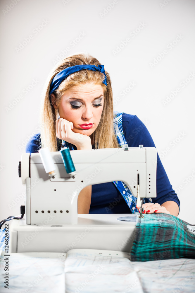 Woman sews and getting tired of work Stock-Foto | Adobe Stock