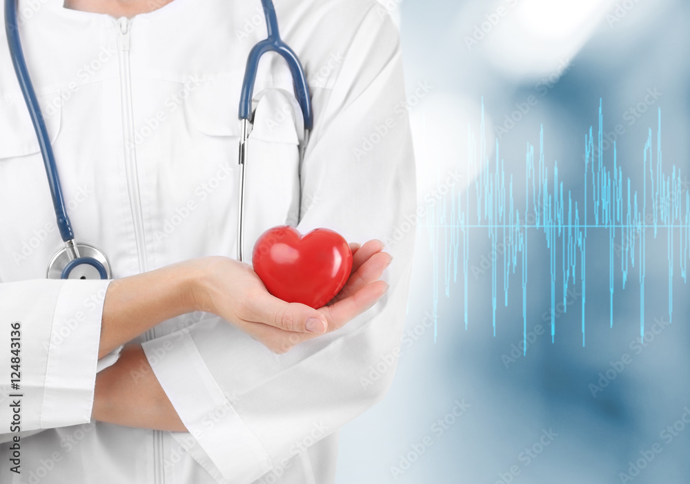 Cardiologist with red heart. Cardiology concept. Stock-Foto | Adobe Stock