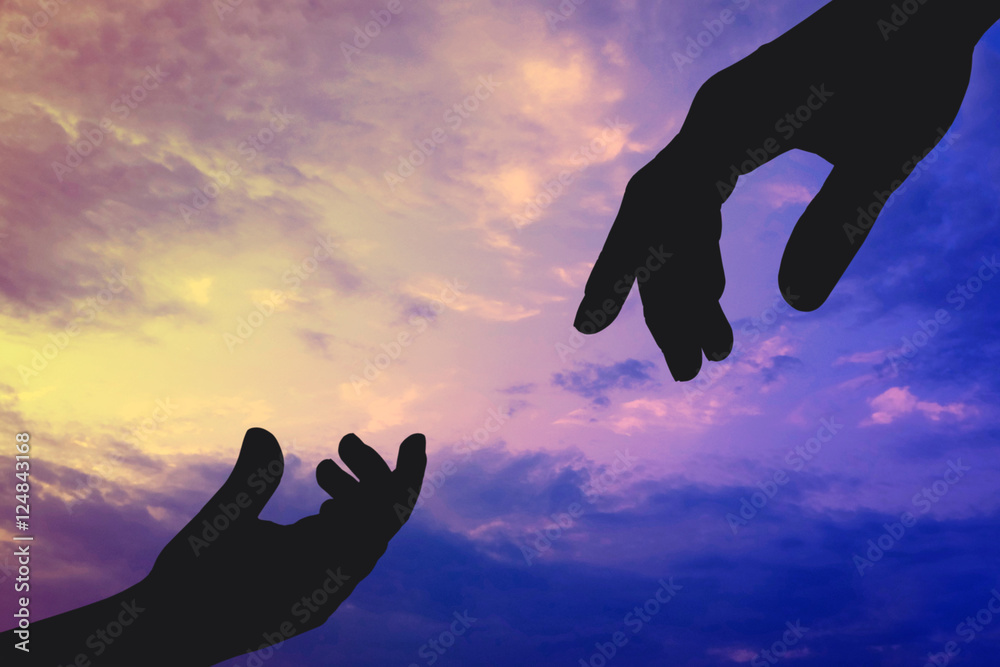 Silhouettes of father and child hands reaching to each other on sky ...