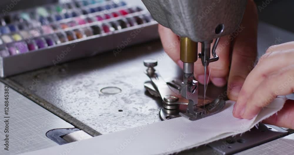 Super slow motion of a professional sewing machine stitching with white ...