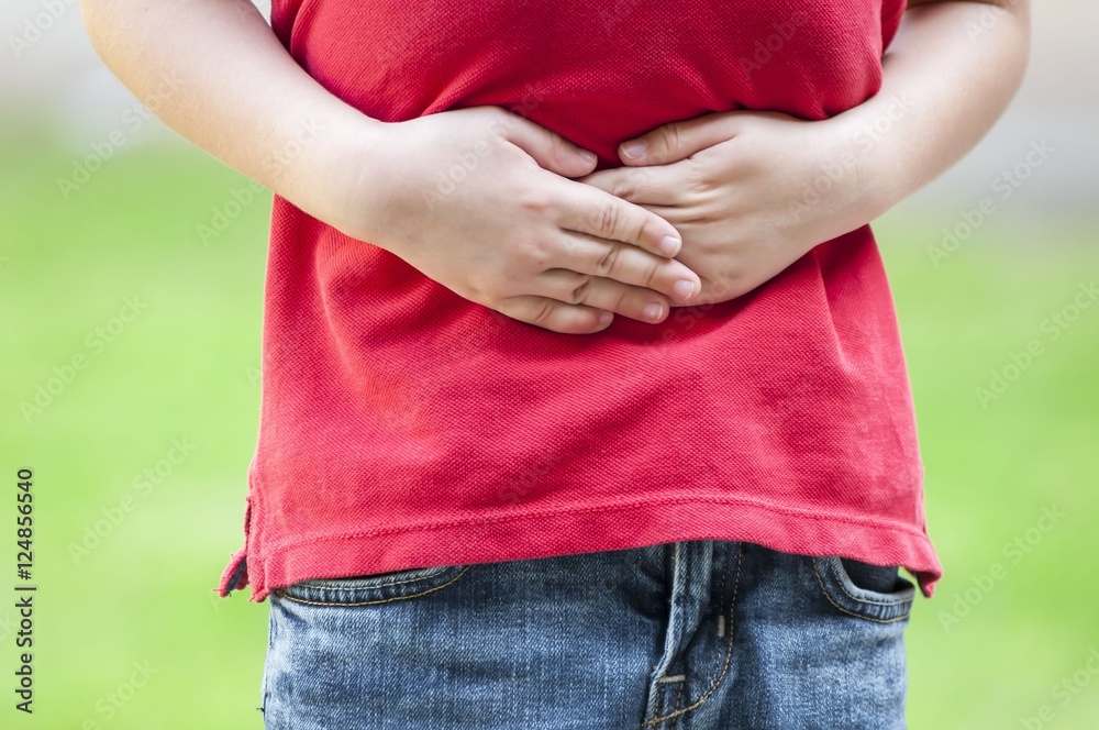 Child with stomach ache, little boy holding hands on his belly. Stock ...