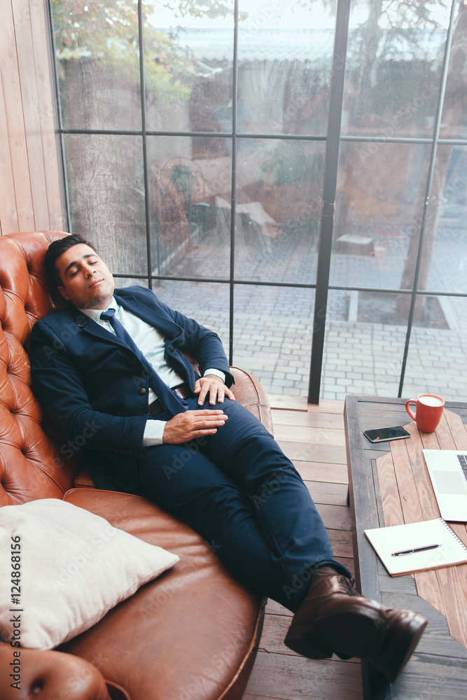 Lazy bad worker with closed eyes lying on sofa in office. Sleepy ...