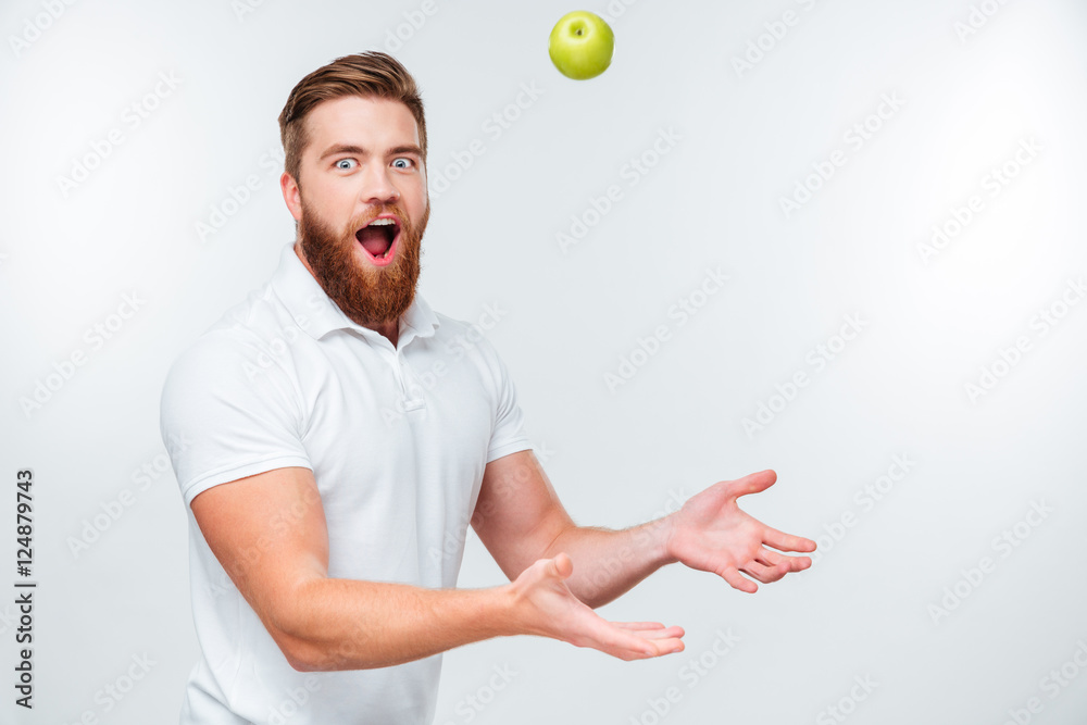 Portrait of handsome funnny bearded man throwing apple up Stock-Foto ...