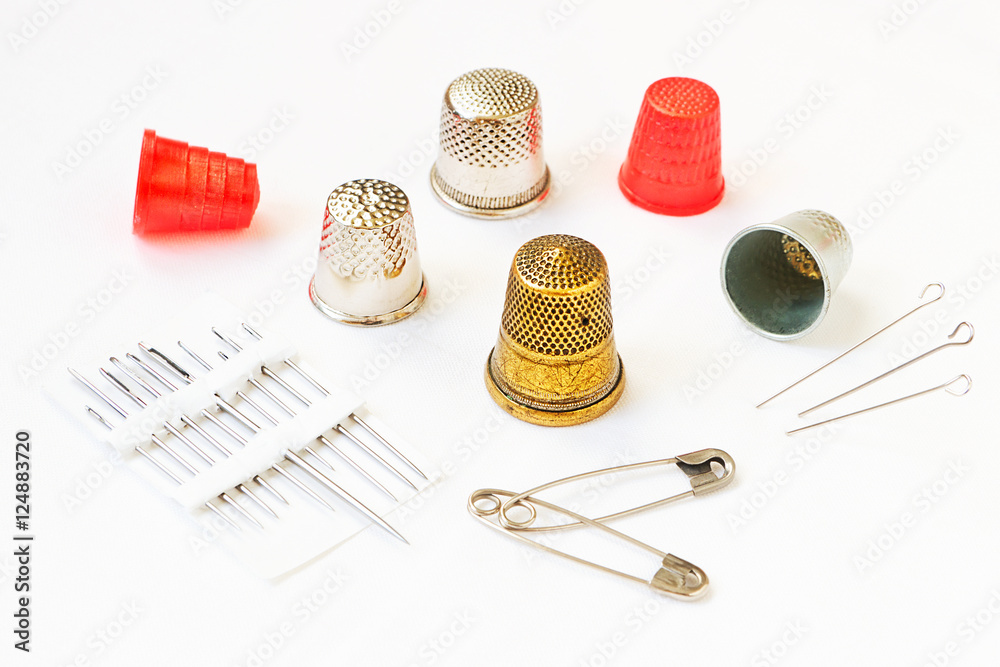 Various thimbles and sewing needles Stock Photo | Adobe Stock