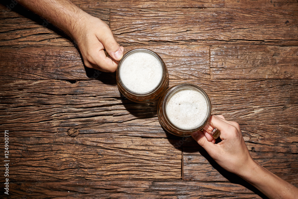 Hände beim anstoßen mit Bier Stock Photo | Adobe Stock