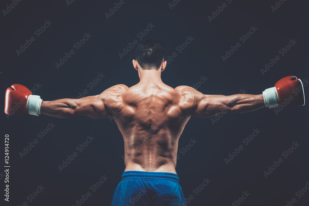 Muscular boxer in studio shooting, on black background. Stock Photo ...