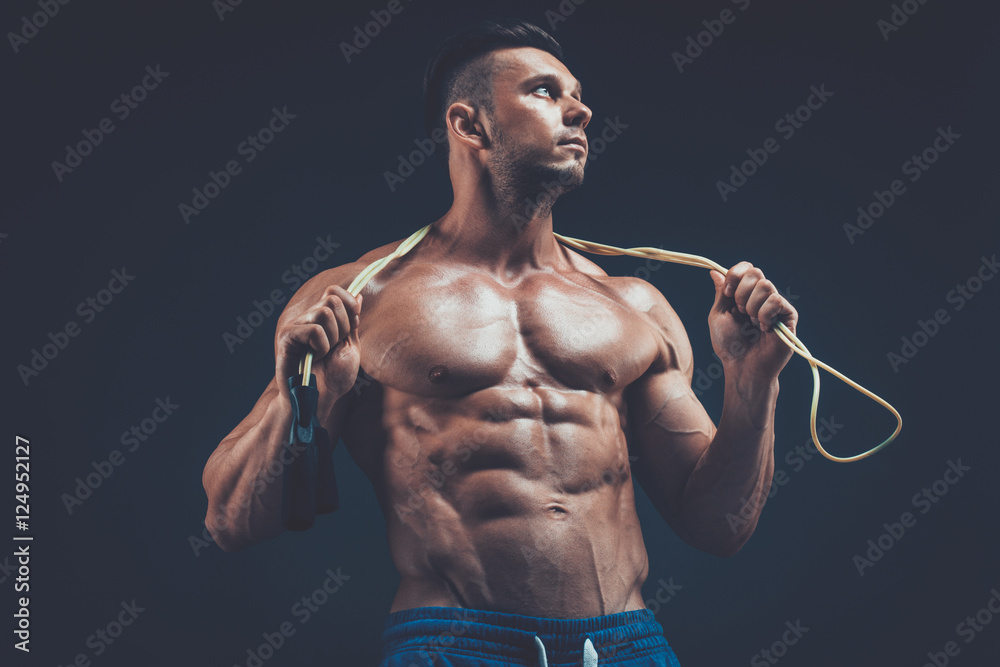 Muscular man skipping rope. active sport fitness Stock Photo | Adobe Stock