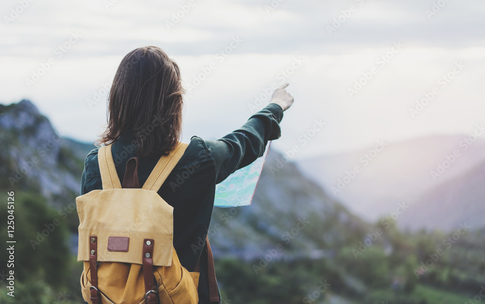 Hipster young girl with backpack enjoying sunset on peak of foggy ...