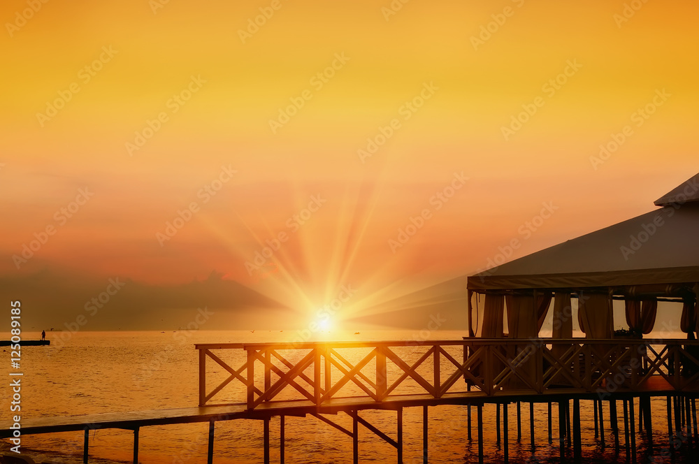 pergola veranda on stilts on the beach at dawn, sunset. Beautiful sky ...
