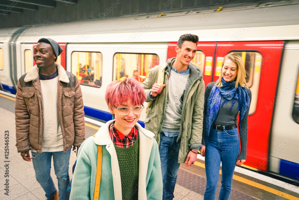 Multiracial group of hipster friends having fun in tube subway station ...