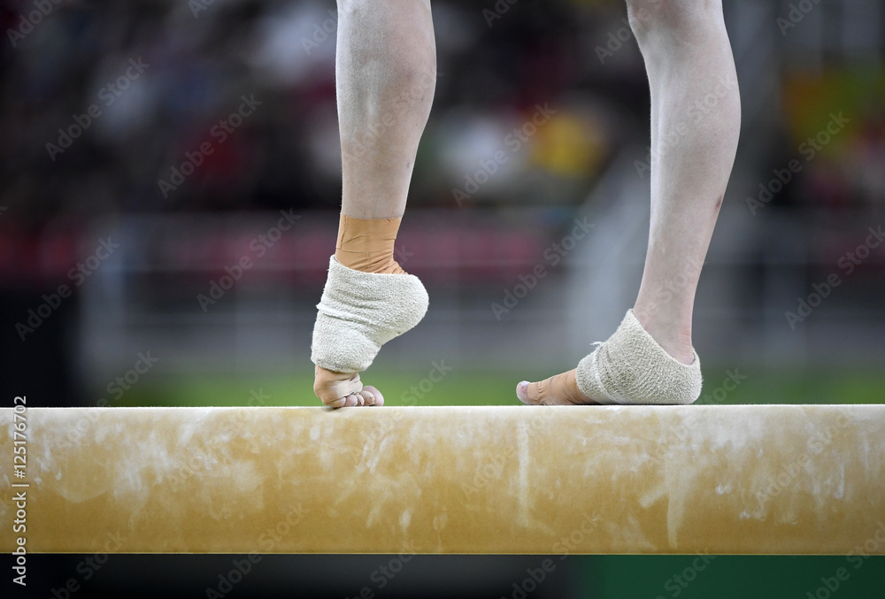 Female gymnast on balance beam during competition Stock Photo | Adobe Stock