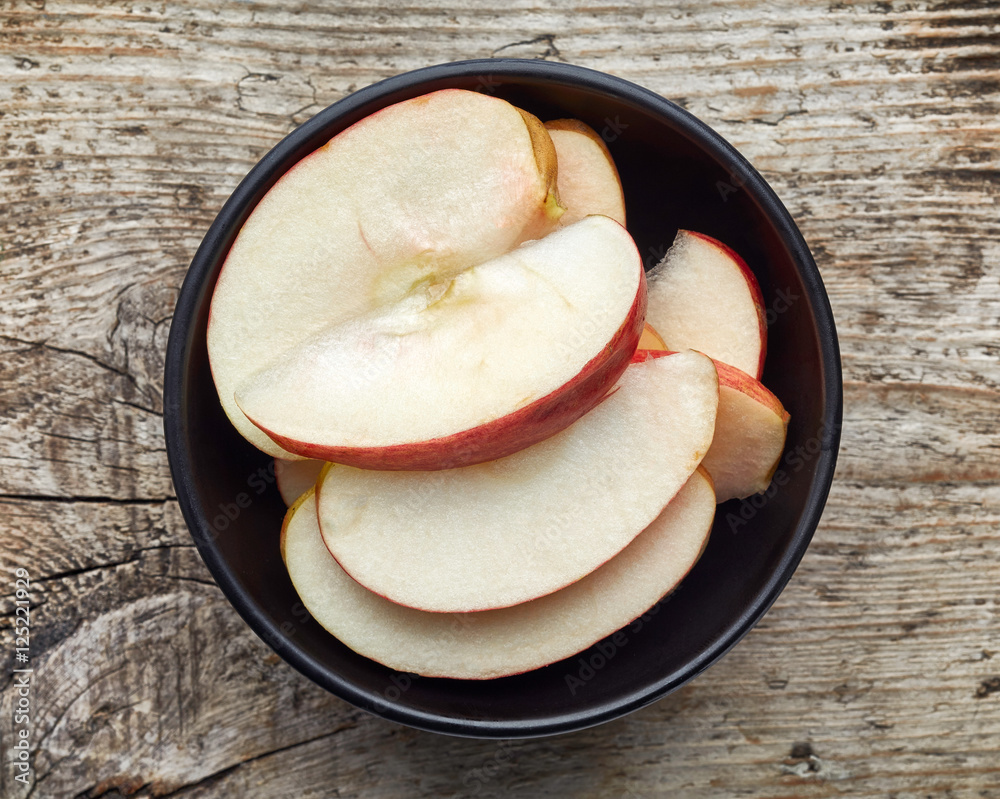 Bowl of sliced apple, from above Photos | Adobe Stock