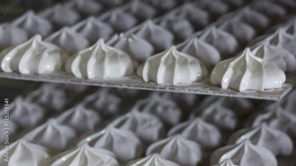 Rows of finished marshmallow zephyr at confectionery factory. Sweet ...