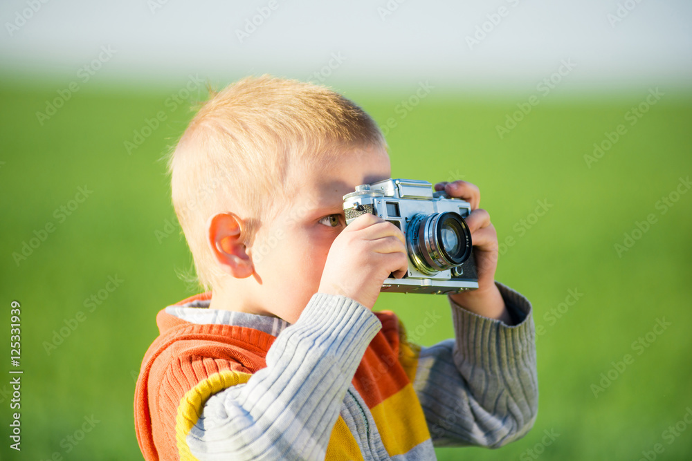Little boy with an old camera shooting outdoor. Kid taking a photo ...