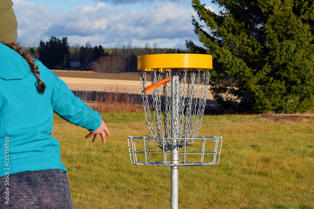 Young woman throws disc to target on disc golf course. Stock Photo ...