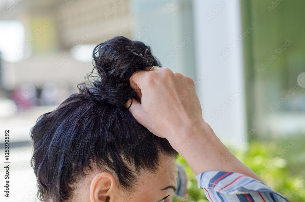 girl putting up her hair Stock Photo | Adobe Stock