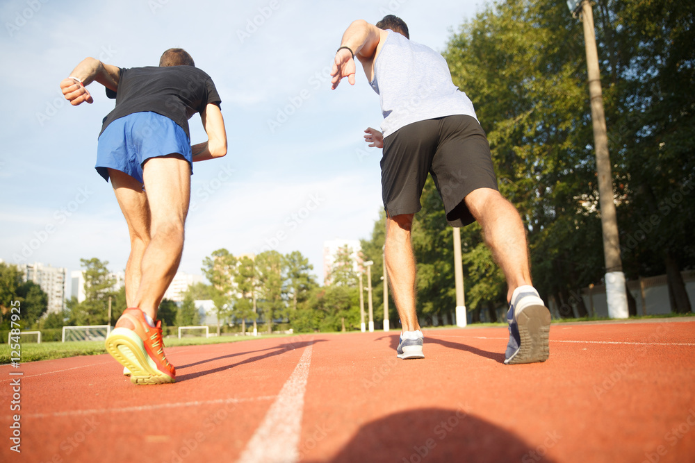 Portrait from behind of two running sports men Stock Photo | Adobe Stock