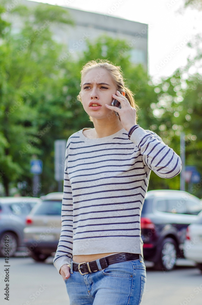 Young woman using her phone Stock Photo | Adobe Stock