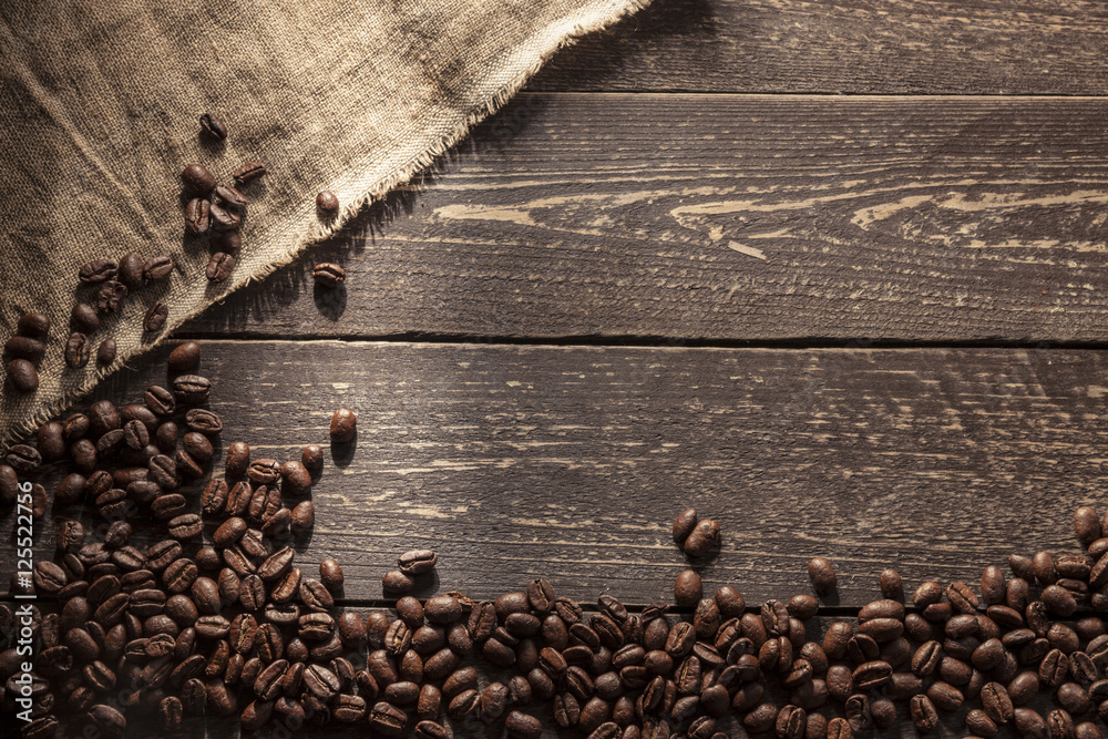 Coffee background. Coffee beans on a wooden dark table with jute bag ...