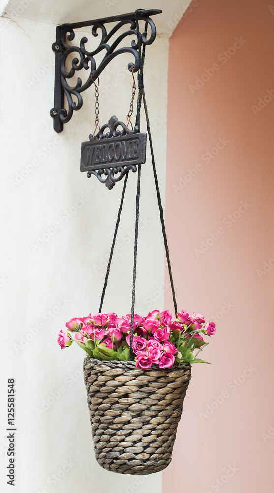 Multi-colored spring flowers hanging in a basket Stock Photo | Adobe Stock