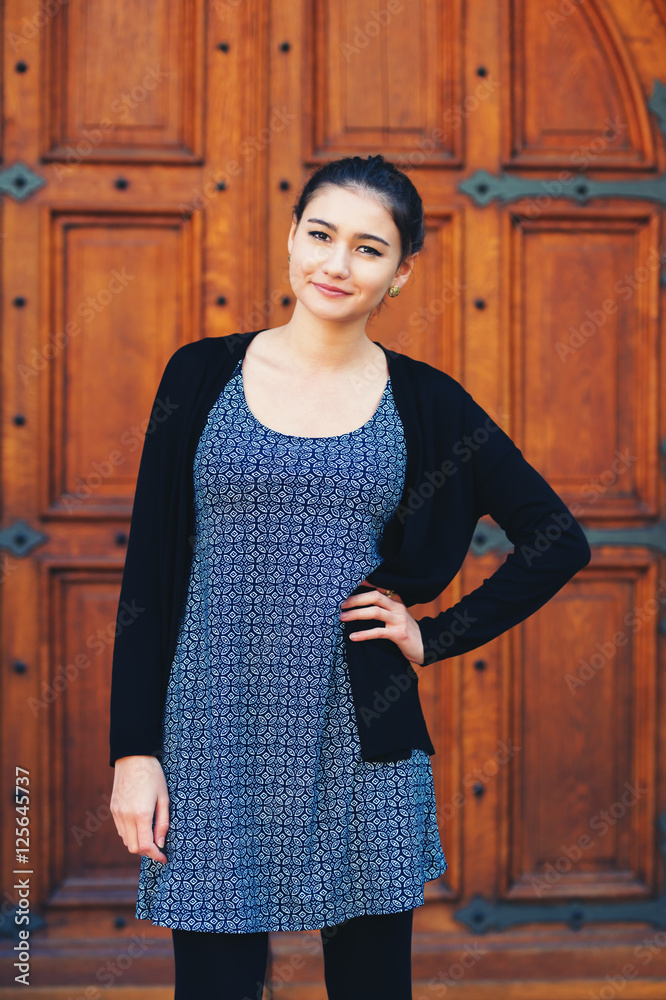 Outdoor fashion portrait of young 20 year old girl wearing blue dress ...