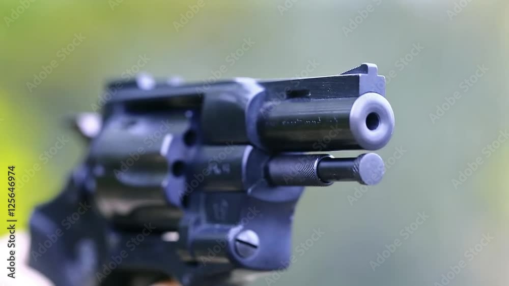 Shots from a revolver. Man shoots a revolver. Shots from a black pistol ...