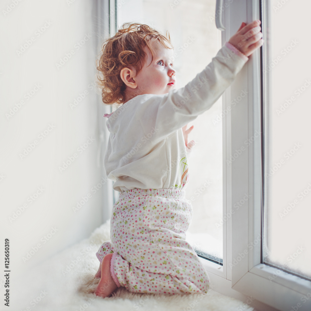 Little girl open the window. Stock Photo | Adobe Stock