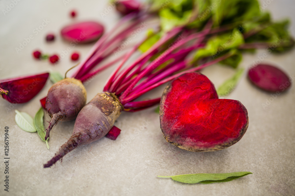 Fresh harvested beetroots . Beets with leaves on light stone background ...