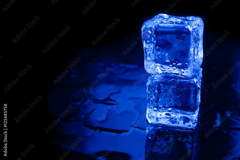Pile of different wet ice cubes on black background with blue li Stock ...