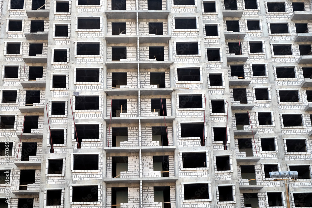 Front view of high-rise modern apartment building construction in ...